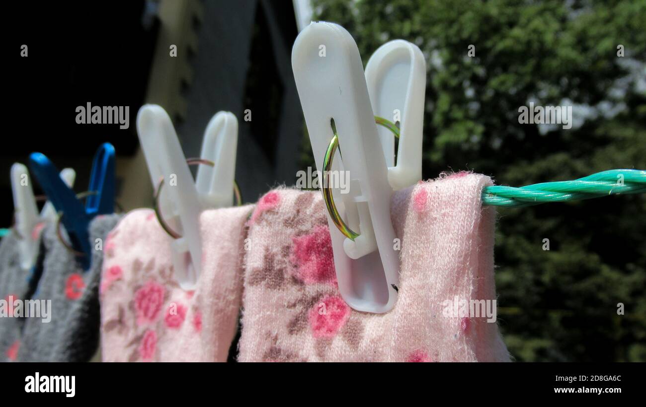 A close up socks hanging from a clothes line Stock Photo - Alamy