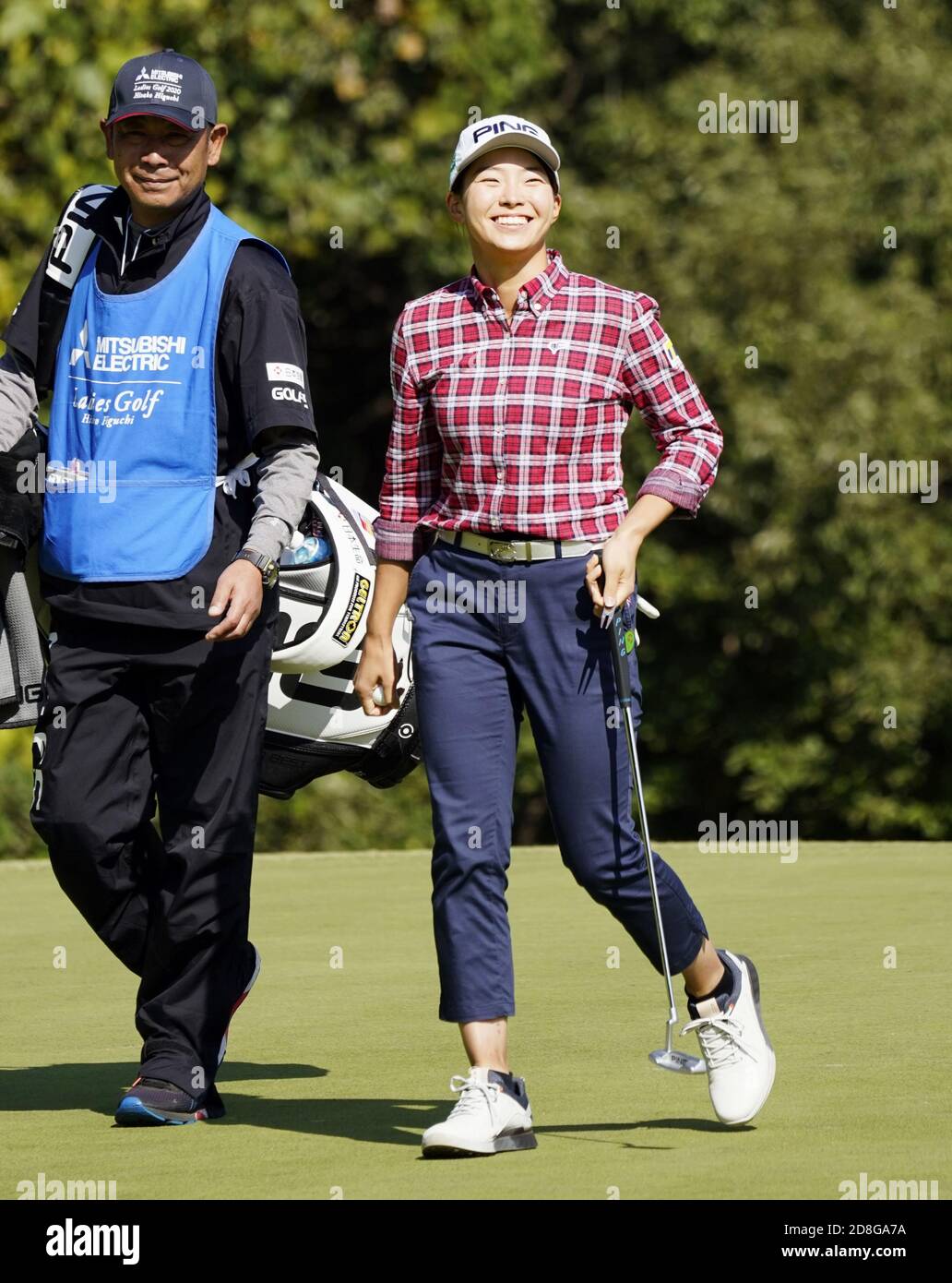 Hinako Shibuno (R) reacts after making a hole-in-one on the eighth hole ...