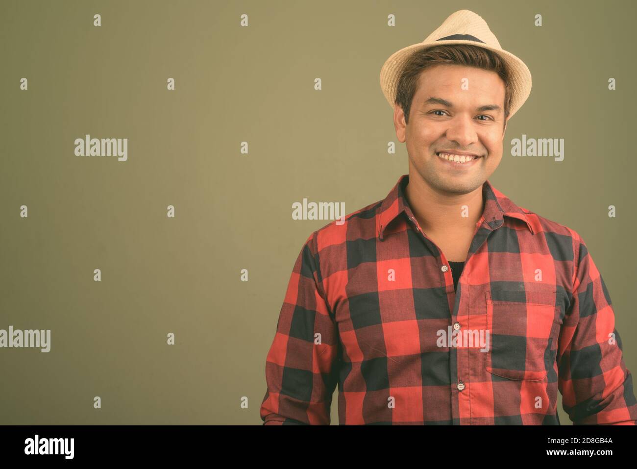 Indian tourist man wearing hat against colored background Stock Photo ...