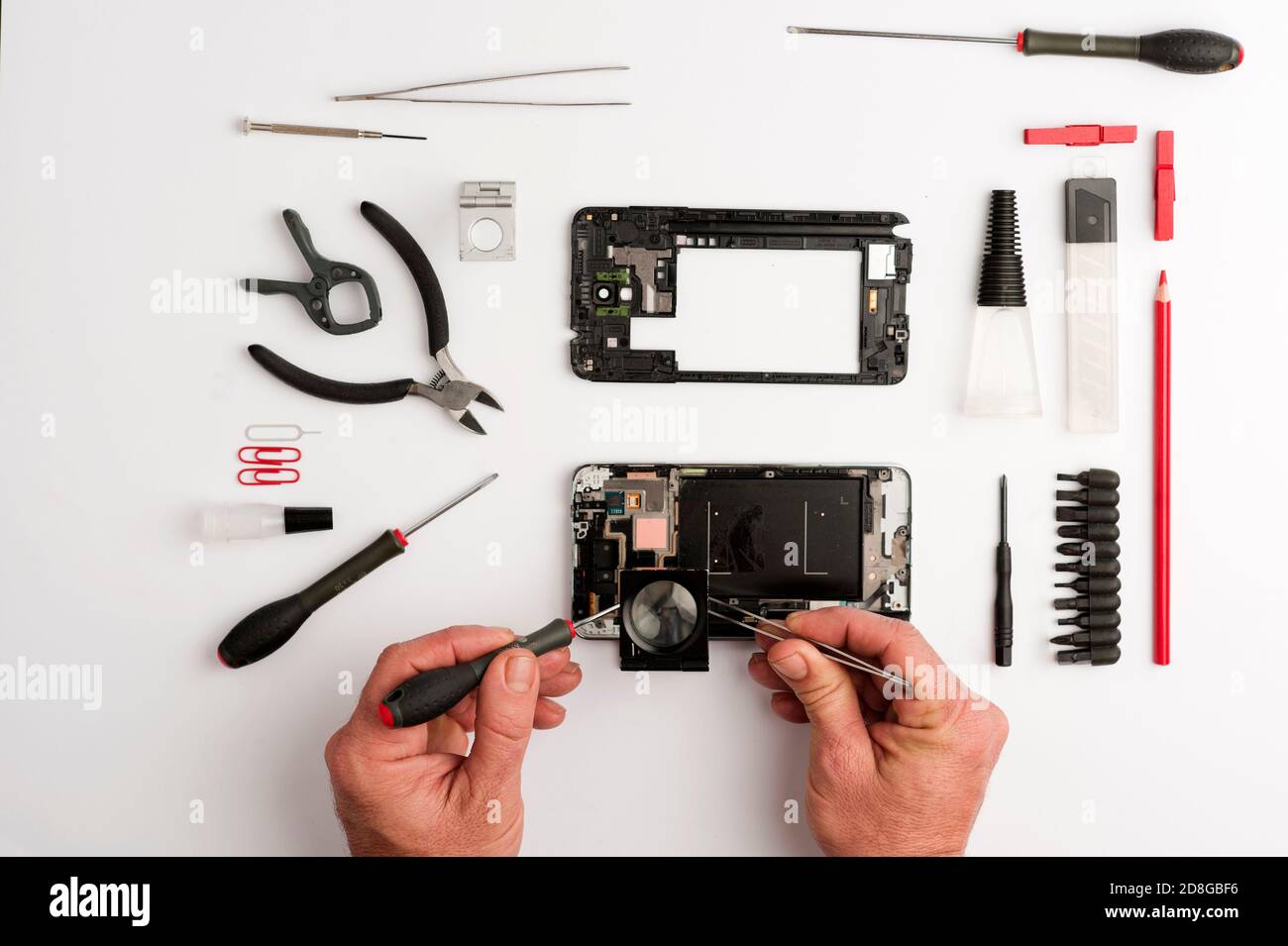 Man working on mobile repair, hands, with tools, screwdrivers, glue ...