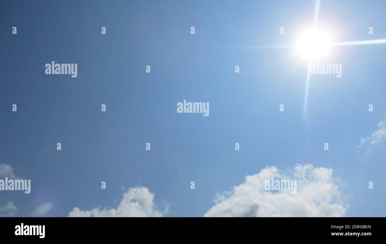 A sky panorama with the sun, blue sky and clouds Stock Photo - Alamy