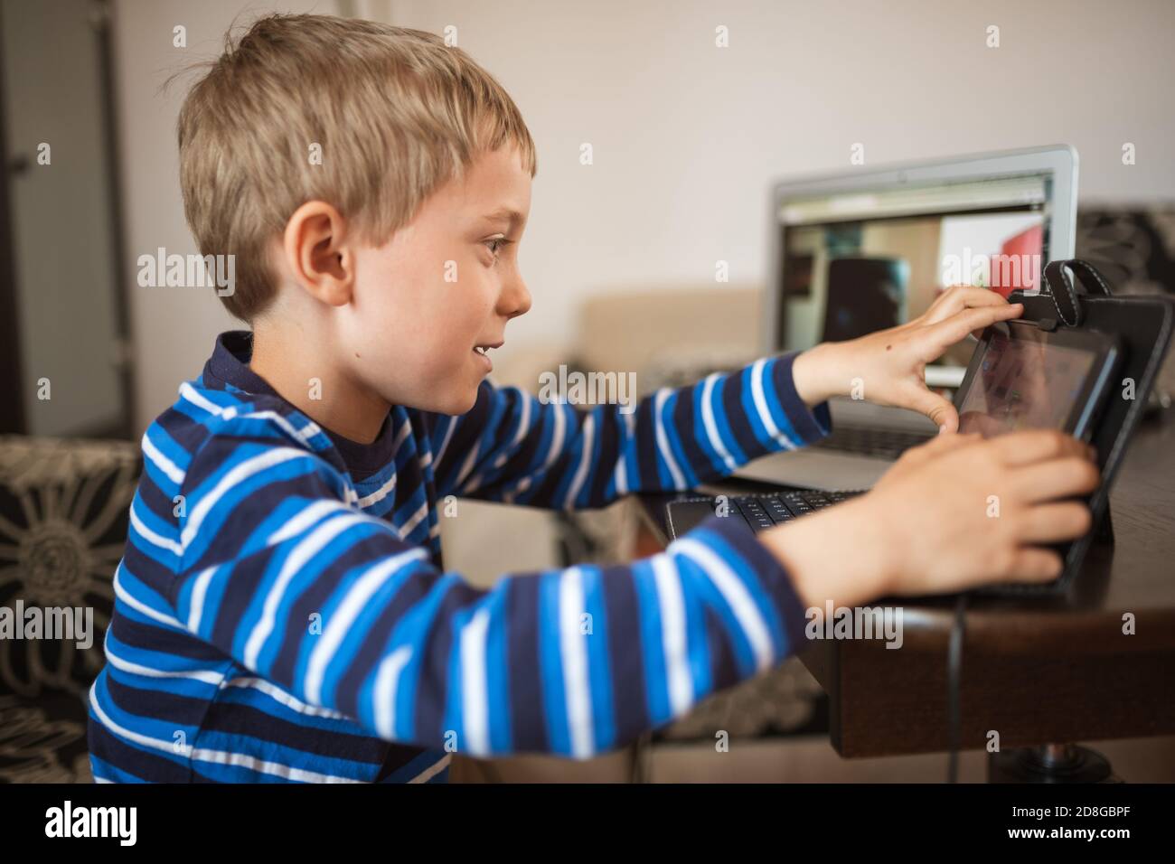 Young boy playing game on the tablet Stock Photo - Alamy