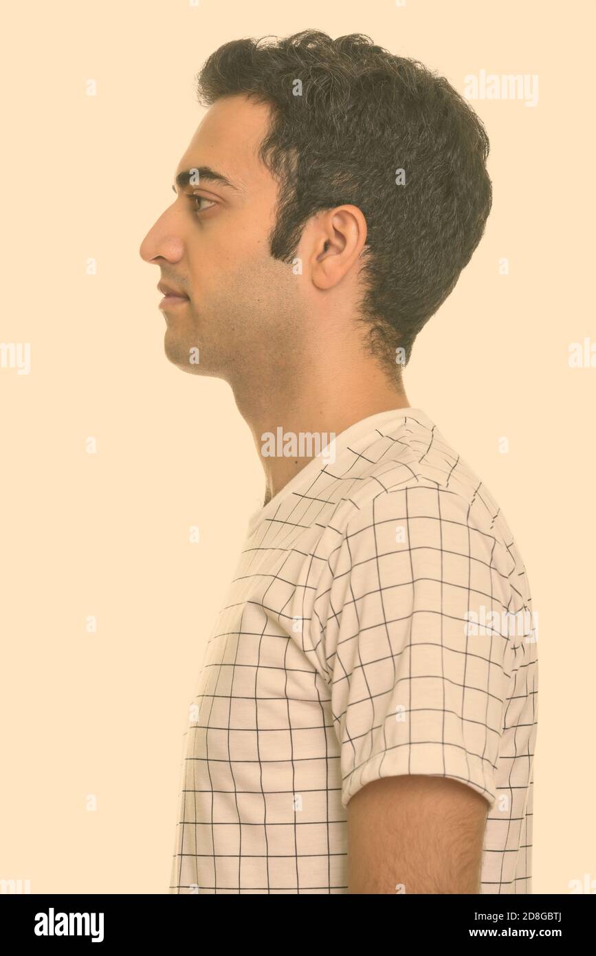 Profile view of young Persian man against white background Stock Photo ...