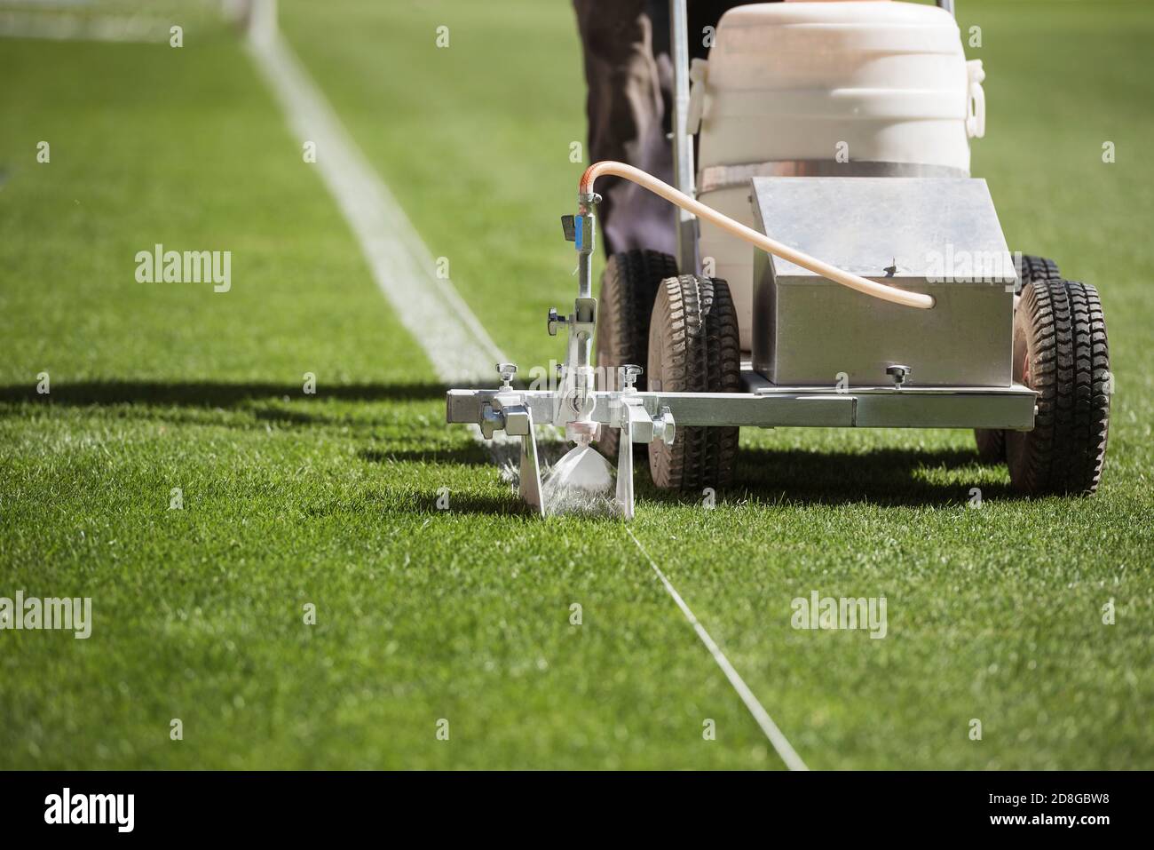Painting line on a soccer pitch Stock Photo - Alamy