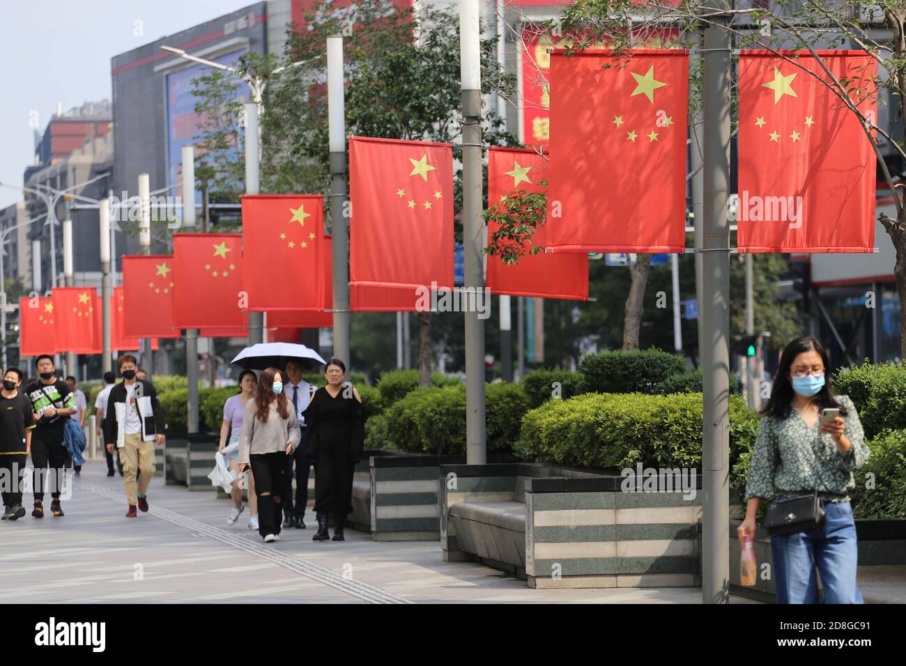 National flags of China are hung in the street light, welcoming the ...
