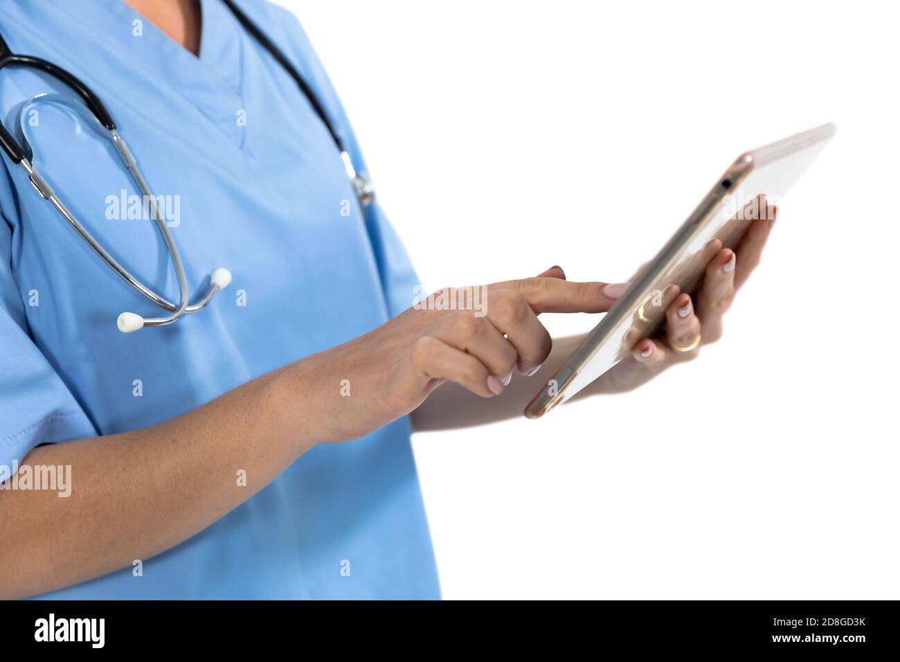 Mid section of female surgeon using digital tablet against white ...