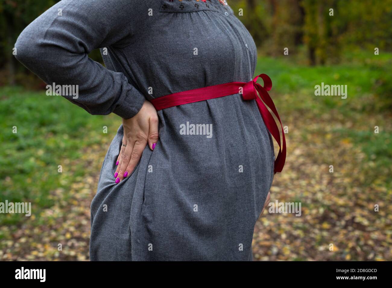 Close up picture of pregnant belly bump in third trimester outdoor in ...
