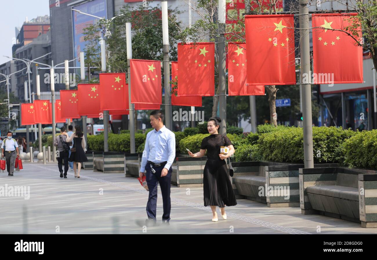 National flags of China are hung in the street light, welcoming the ...