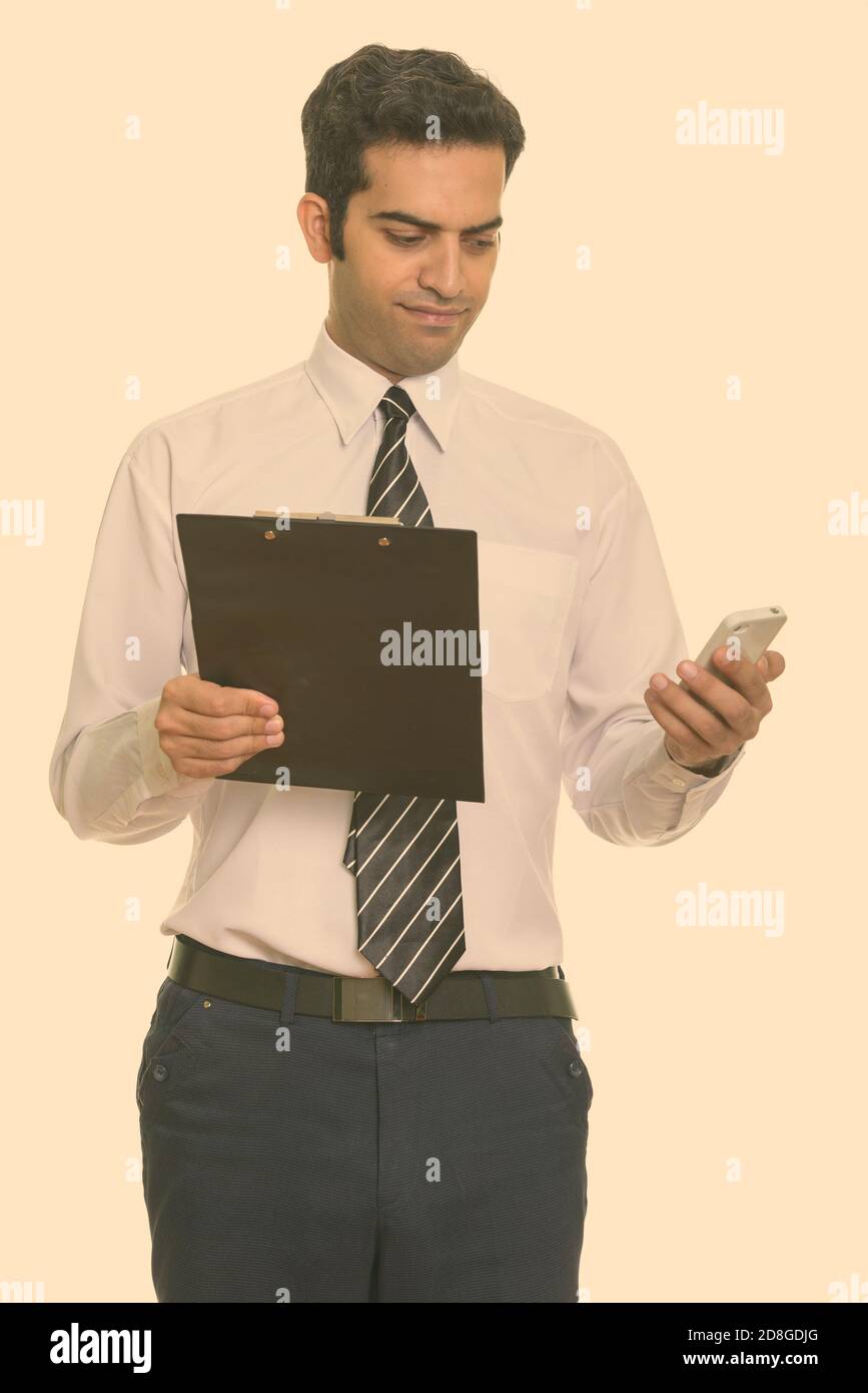 Young Persian businessman holding clipboard and mobile phone Stock ... Young Persian businessman holding clipboard and mobile phone Stock ...