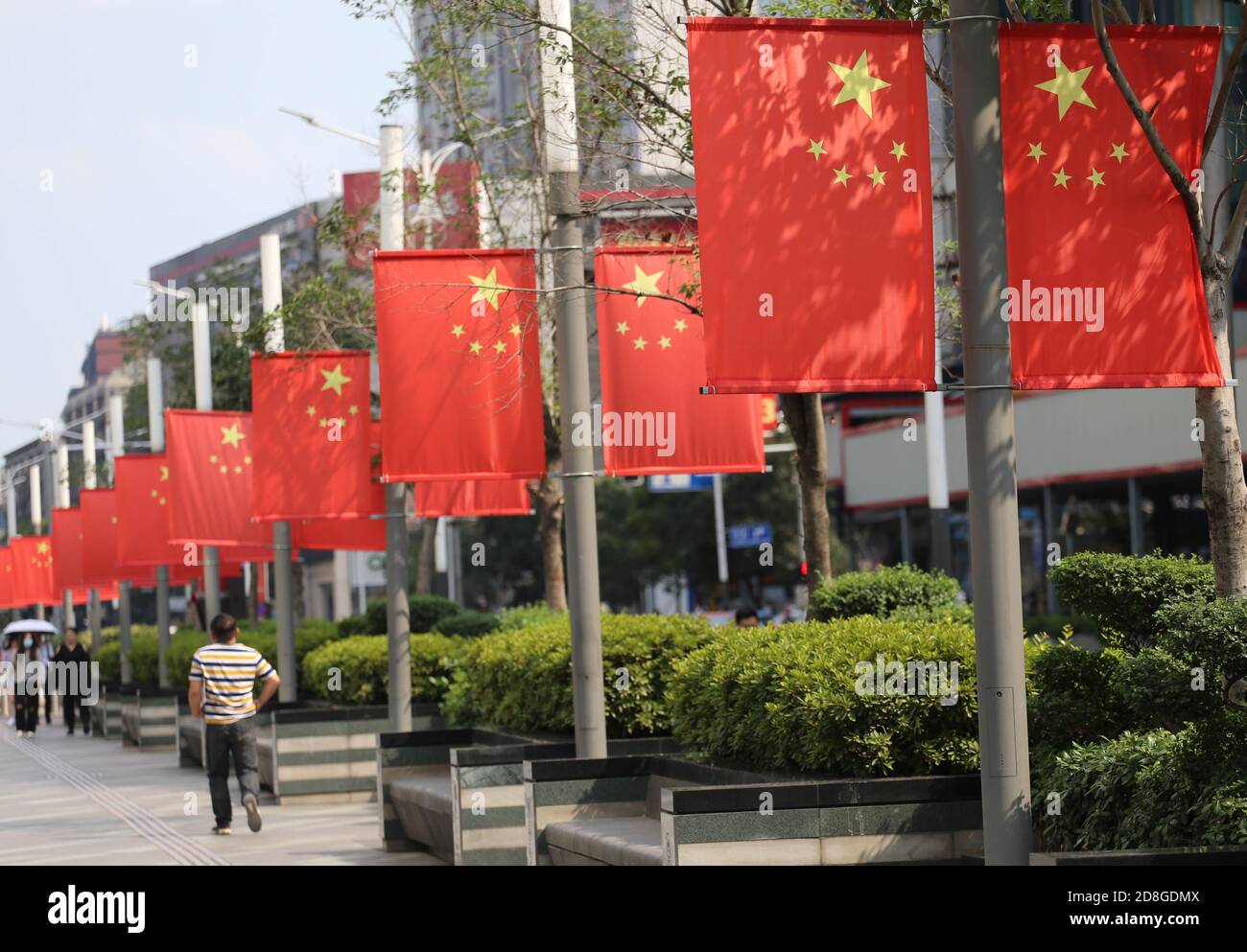 National flags of China are hung in the street light, welcoming the ...