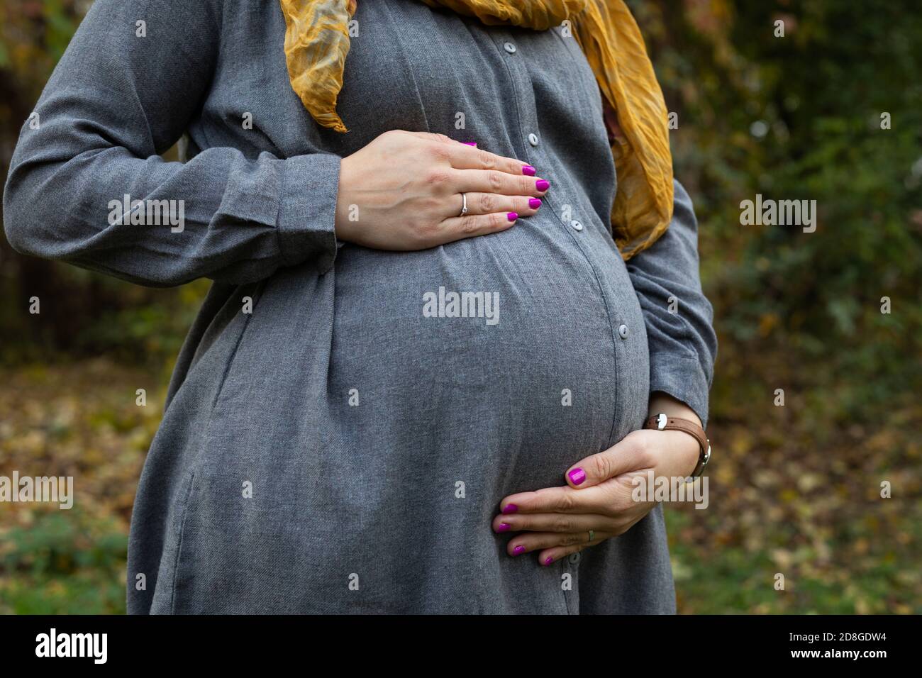 Close up picture of pregnant belly bump in third trimester outdoor in ...
