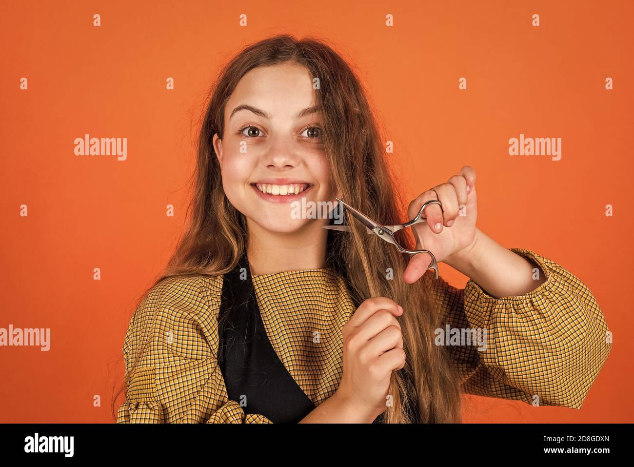 teen girl cut her hair with scissors. making new hairstyle. kid use ...
