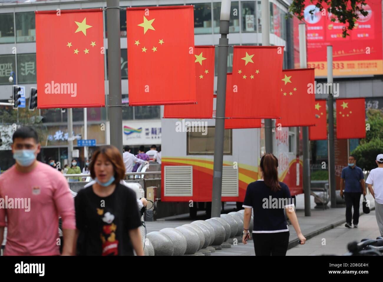 National flags of China are hung in the street light, welcoming the ...