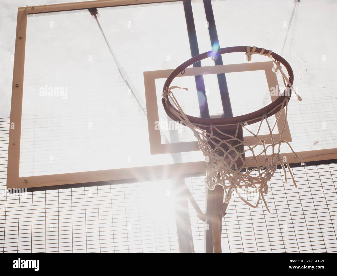 basketball Hoop with glare from the sun Stock Photo - Alamy