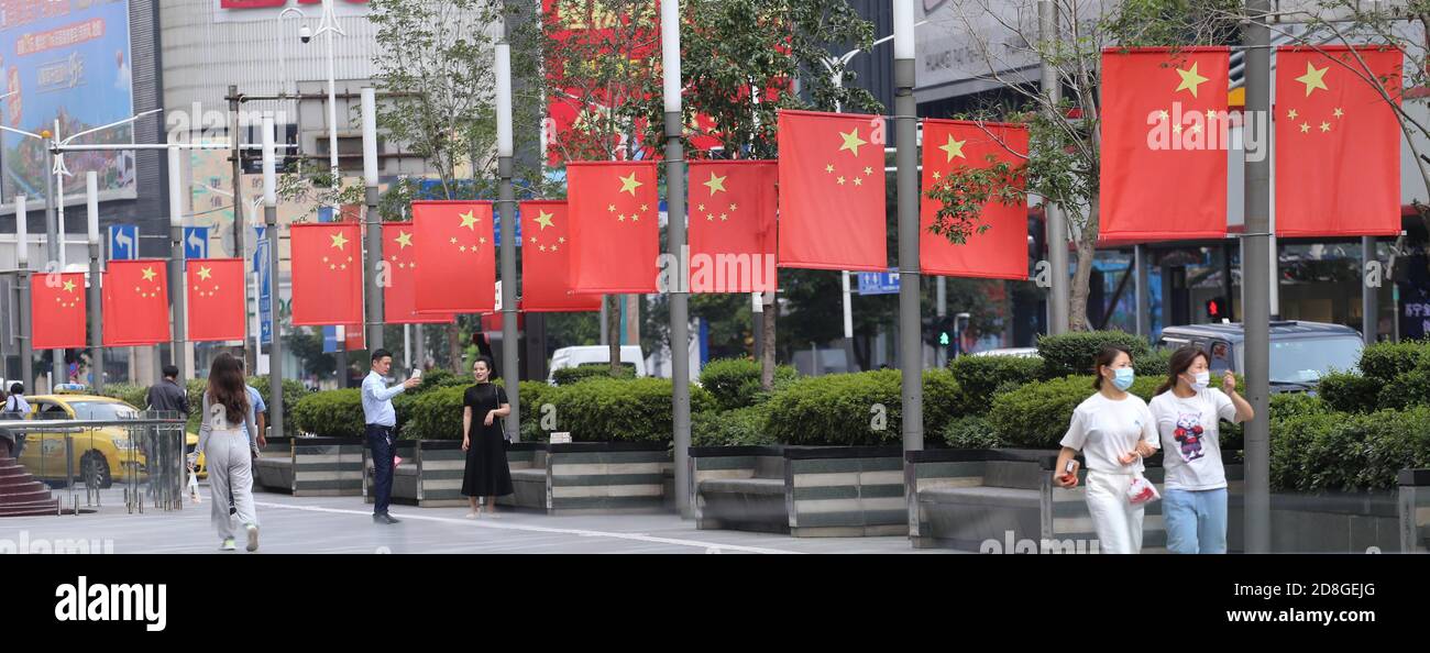 National flags of China are hung in the street light, welcoming the ...