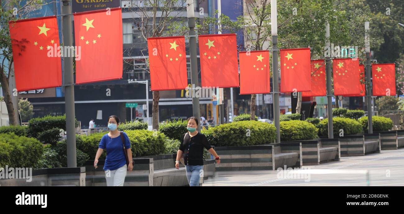 National flags of China are hung in the street light, welcoming the ...