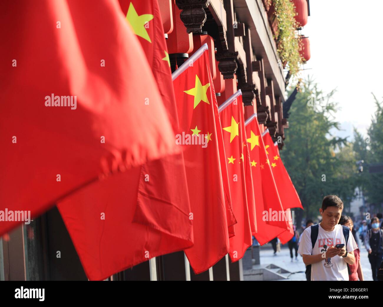 A line of Chinese national flags fly on the street prior to the ...