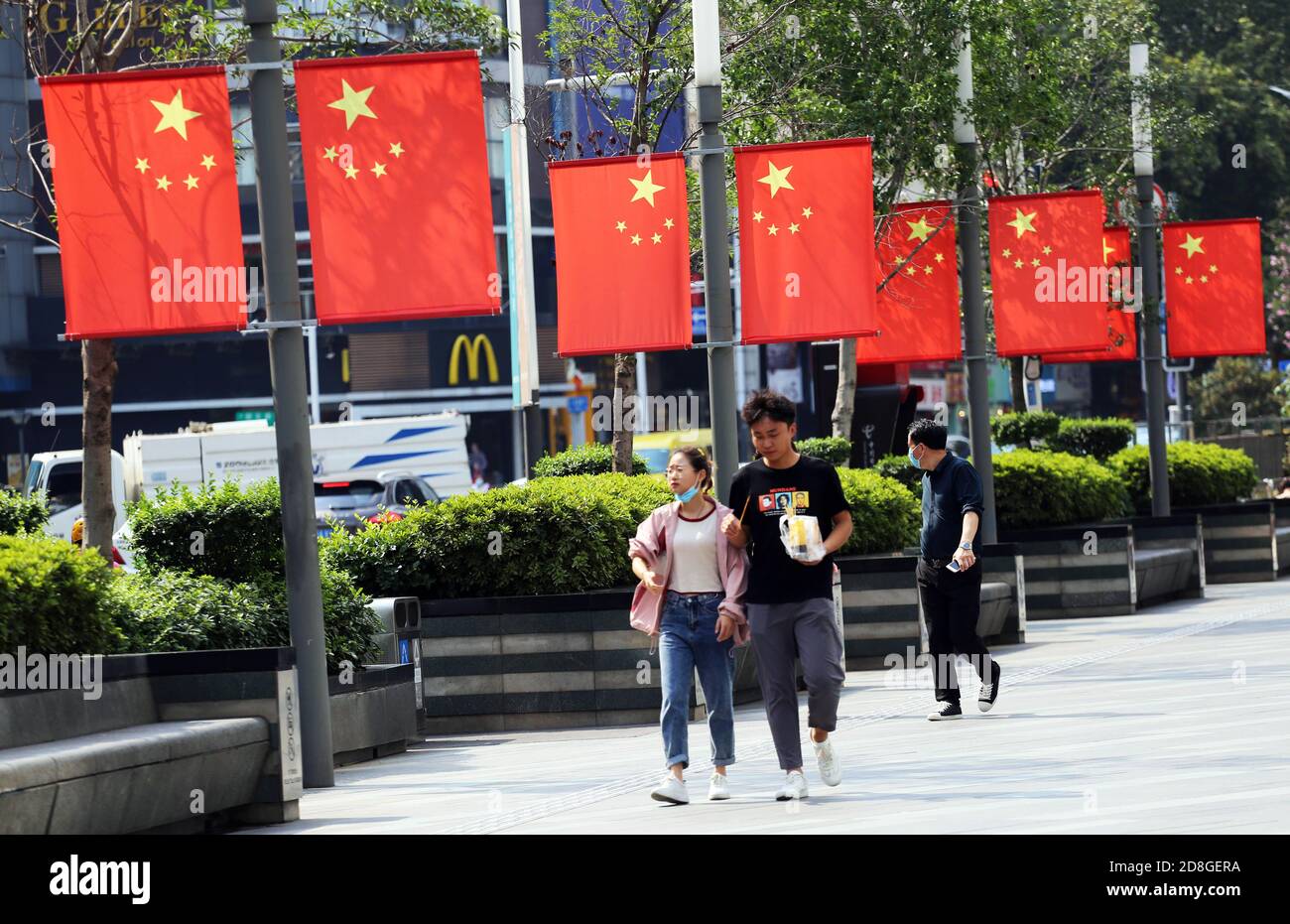 National flags of China are hung in the street light, welcoming the ...