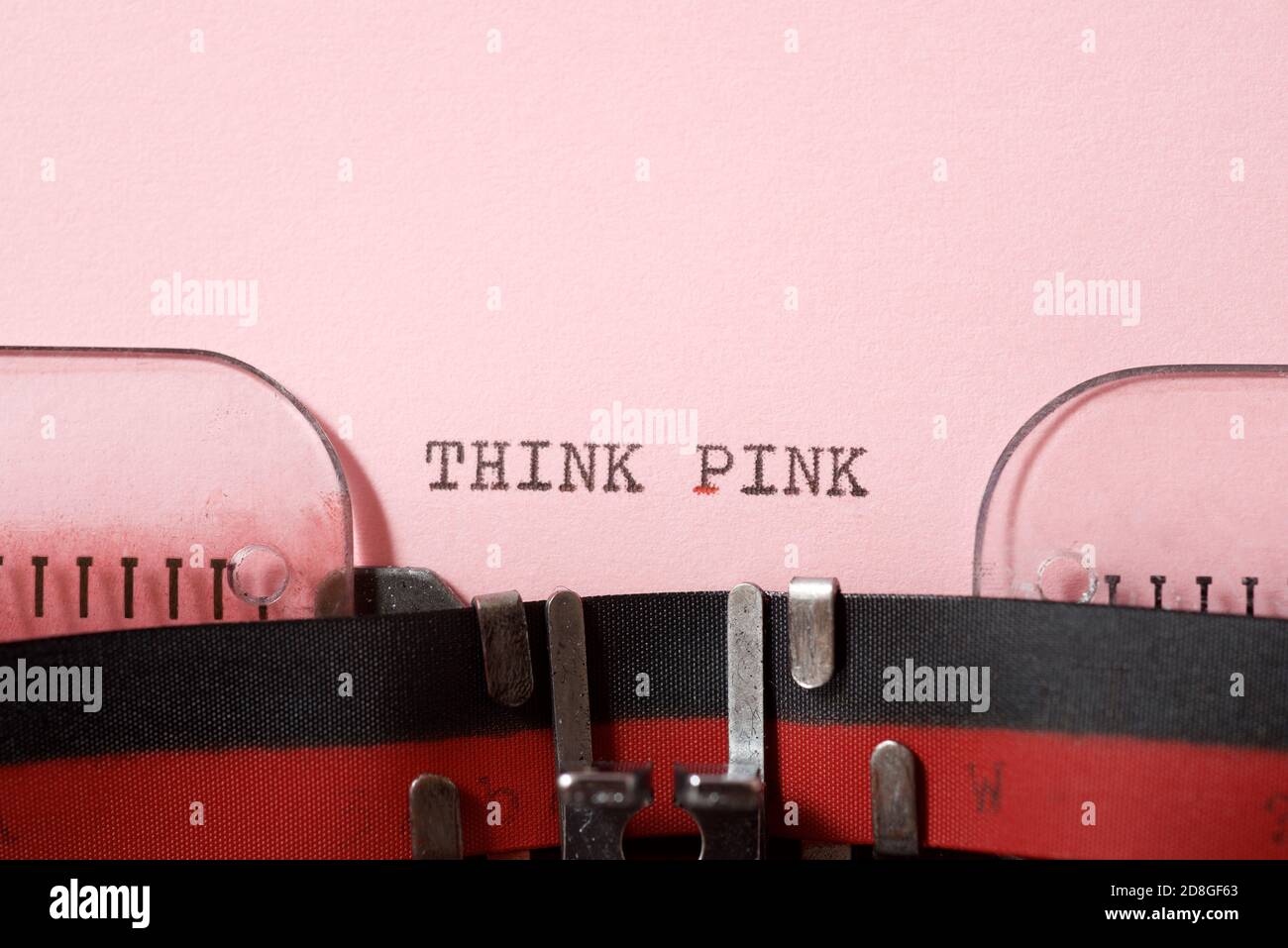 Think pink phrase written with a typewriter Stock Photo - Alamy