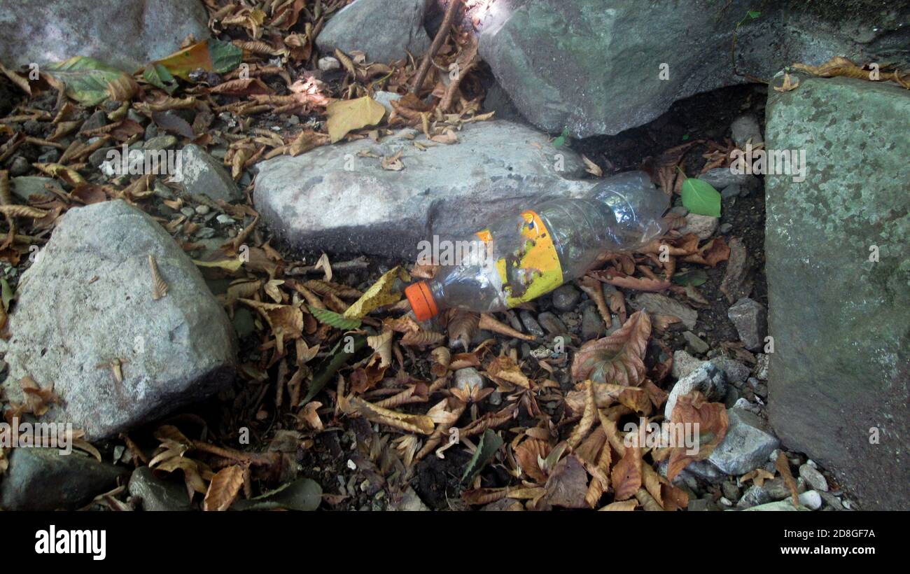Plastic waste. Ecological dirt spilled garbage on the ground of the big ...