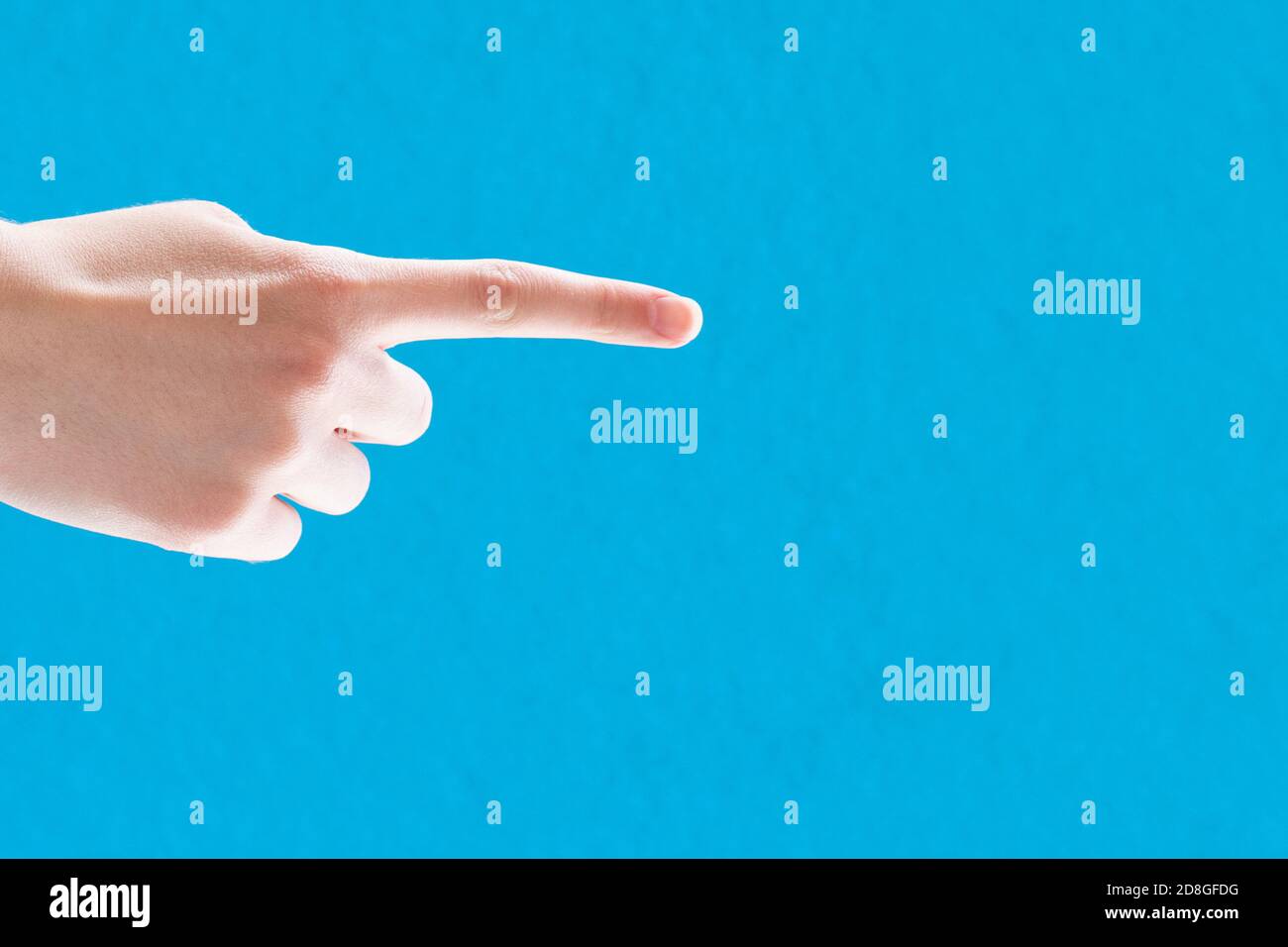 Close-up, woman pointing finger on blue background, copy space Stock ...