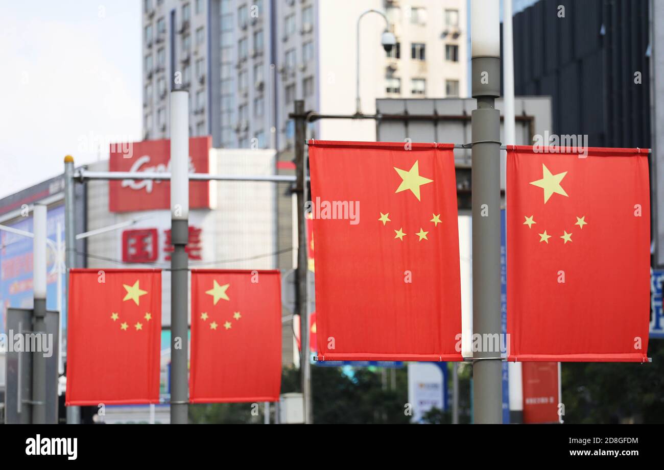 National flags of China are hung in the street light, welcoming the ...