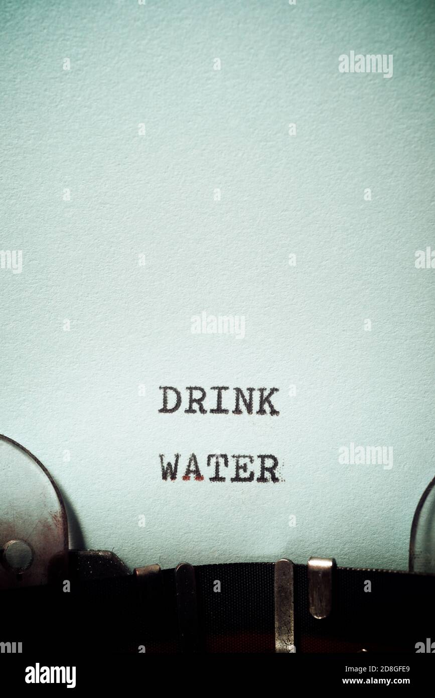 Drink water phrase written with a typewriter Stock Photo - Alamy