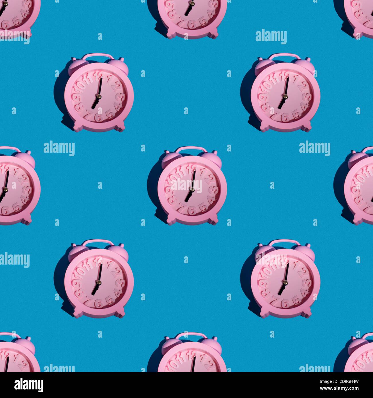 Fashionable pattern with a pink clock on a blue background, repeating ...