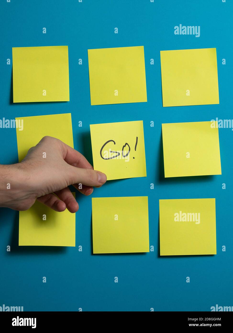 hand take yellow sticker that says GO. motivating banner. empty space ...