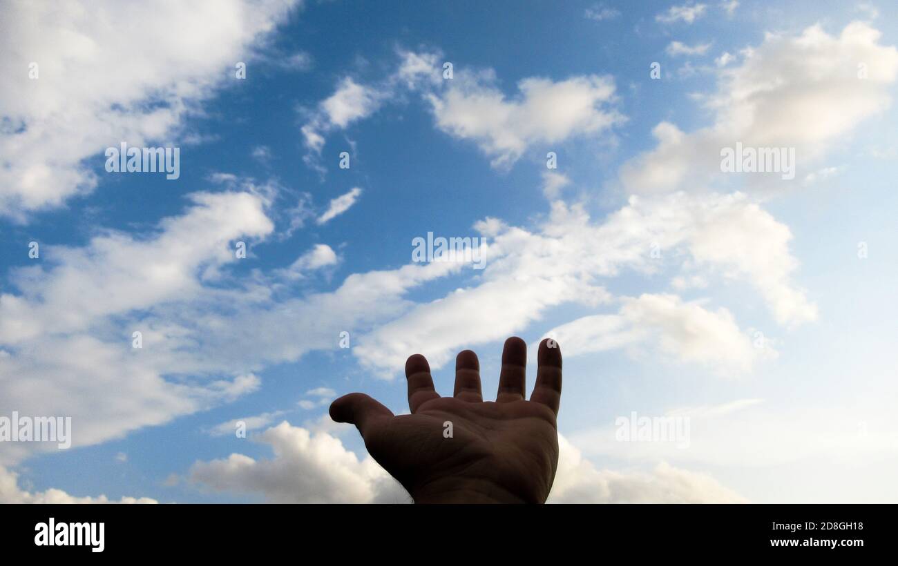 Hand of a man reaching to towards sky Stock Photo - Alamy