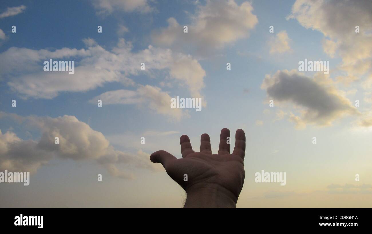Hand of a man reaching to towards sky Stock Photo - Alamy