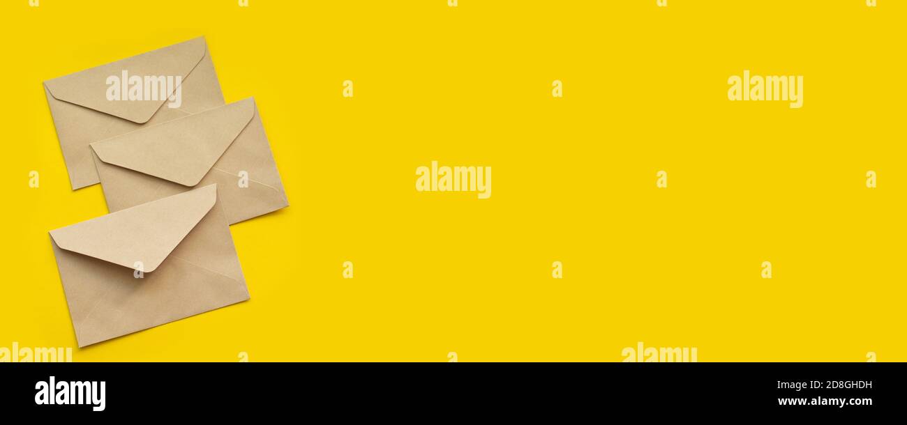 Craft yellow and bright blank envelopes on yellow horizontal background ...