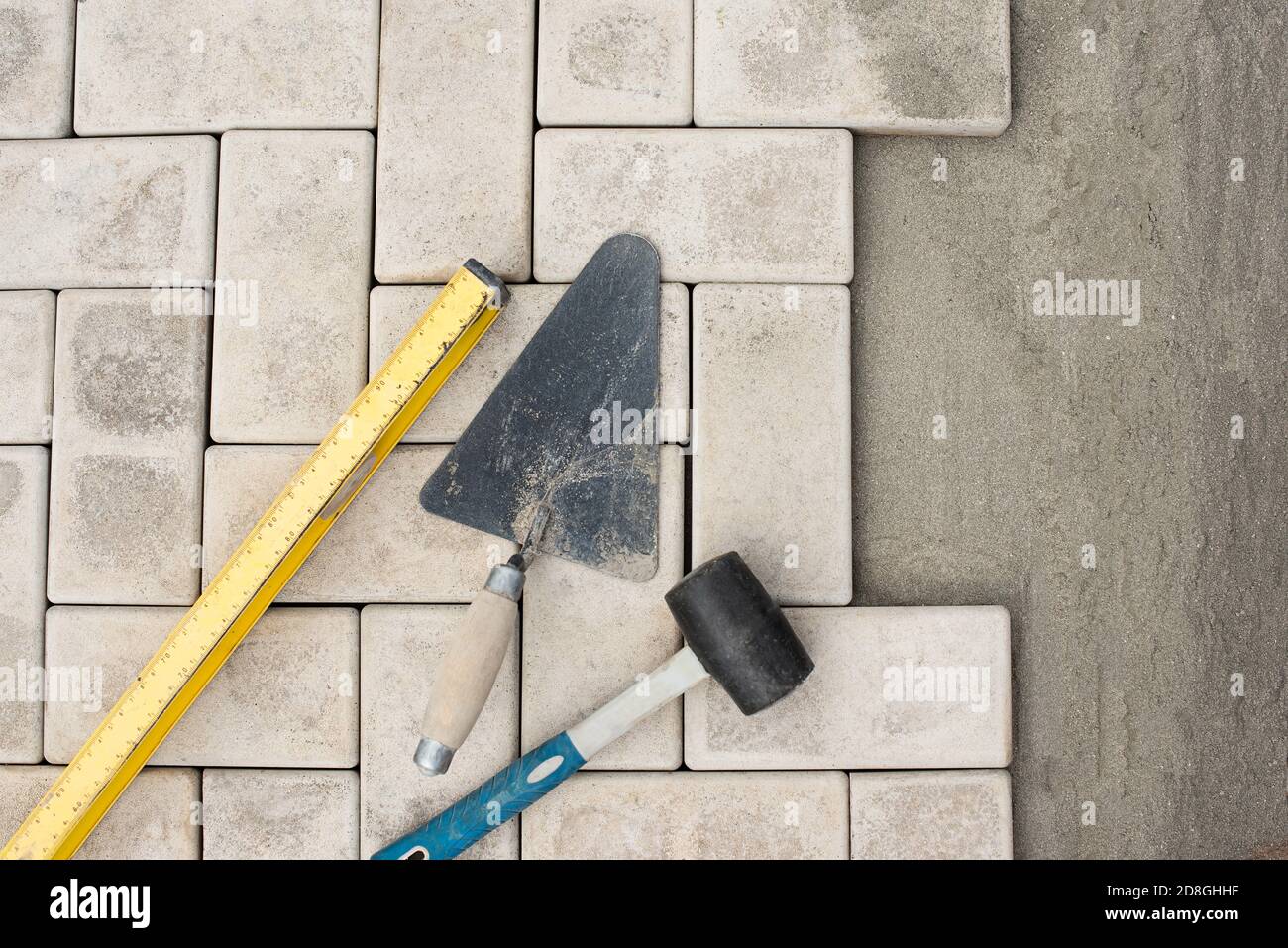 The master lays paving stones in layers. Garden brick pathway paving ...
