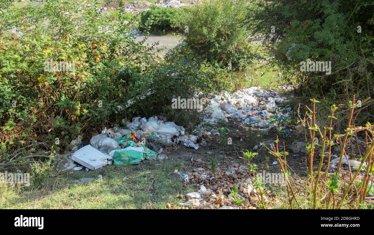 Plastic waste. Ecological dirt spilled garbage on the ground of the big ...