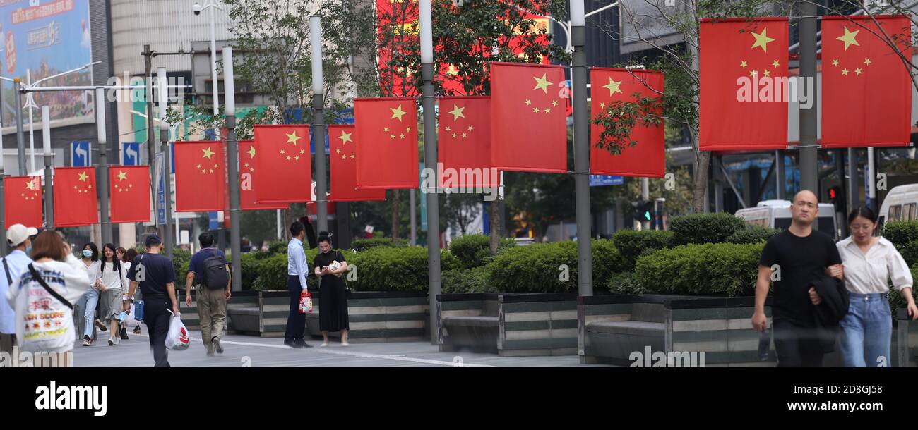 National flags of China are hung in the street light, welcoming the ...