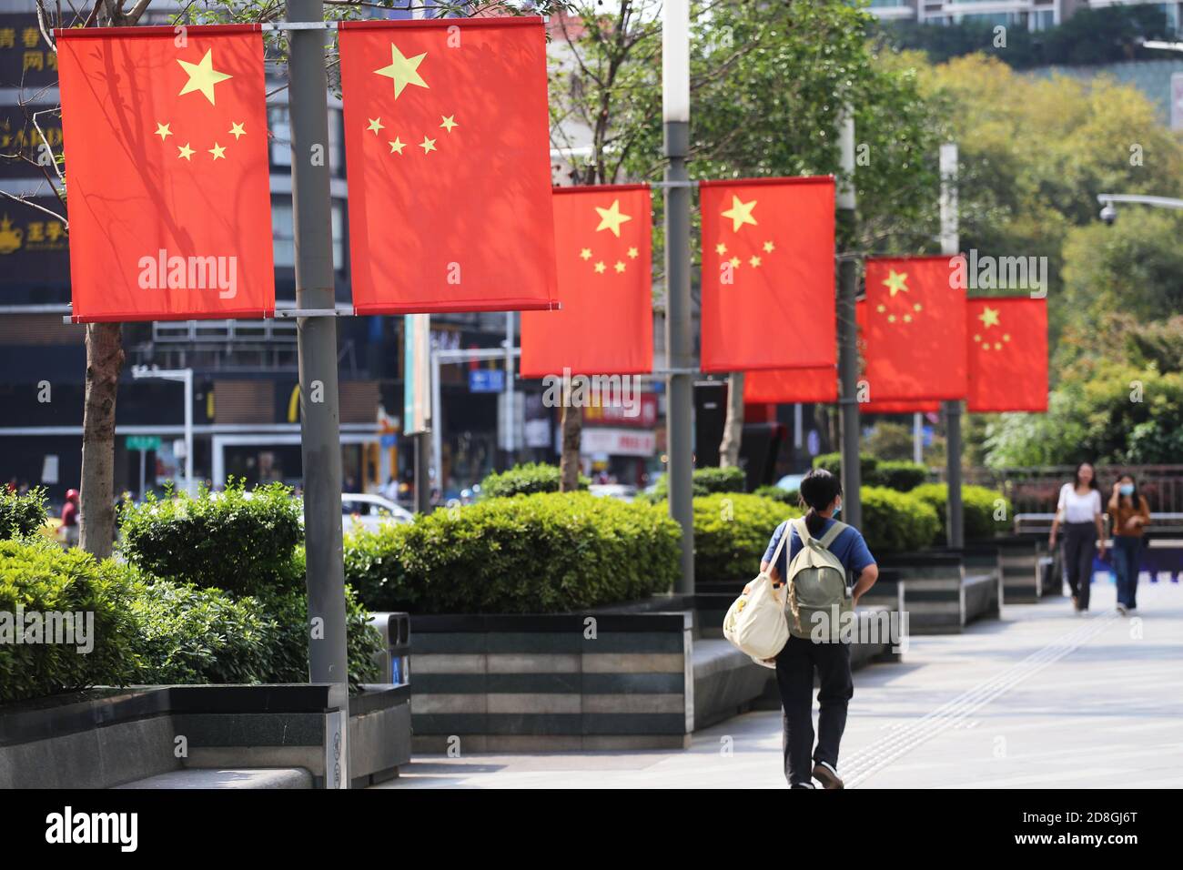 National flags of China are hung in the street light, welcoming the ...