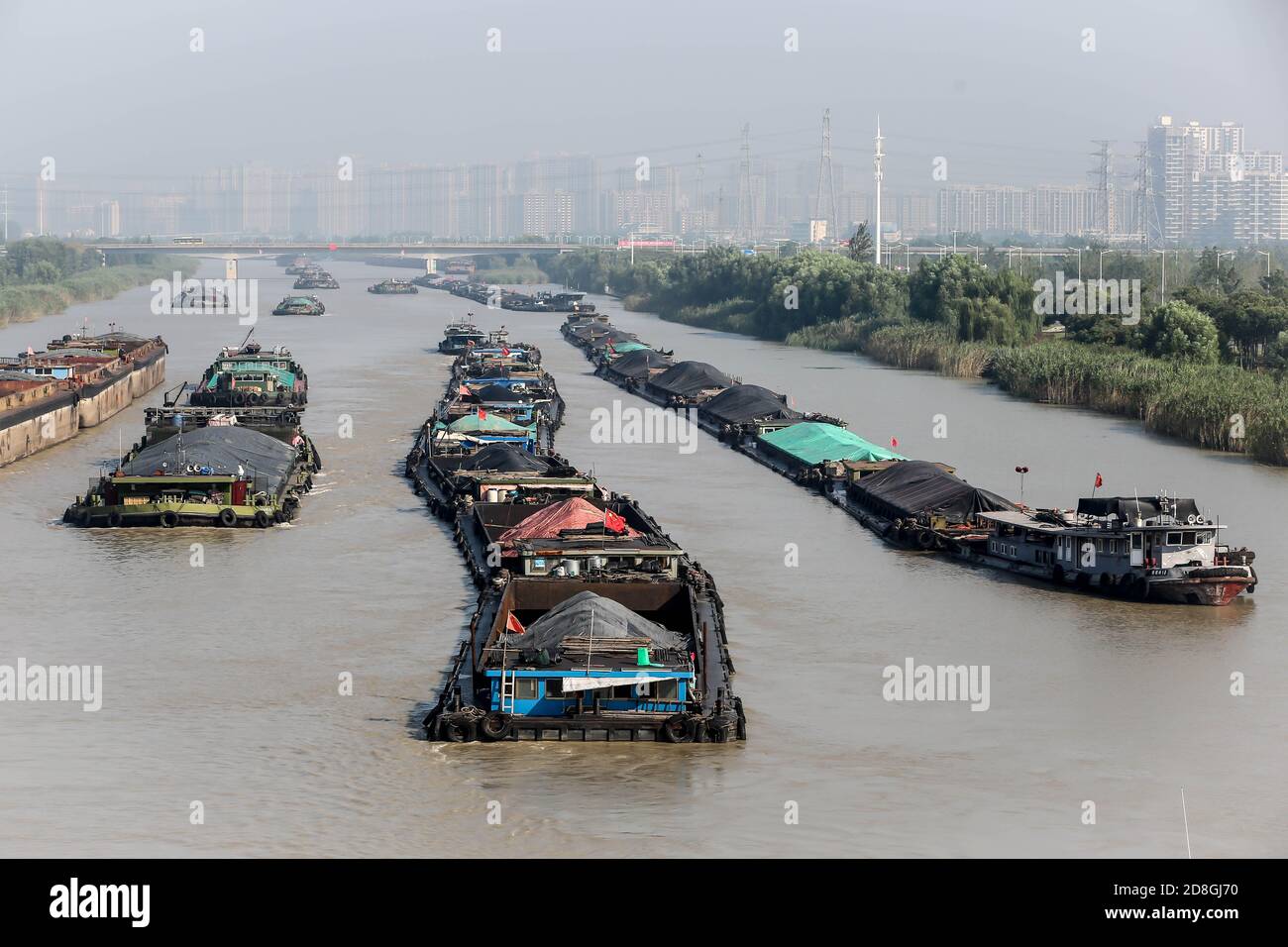 An aerial view of ships containing various kinds of goods moving on the ...