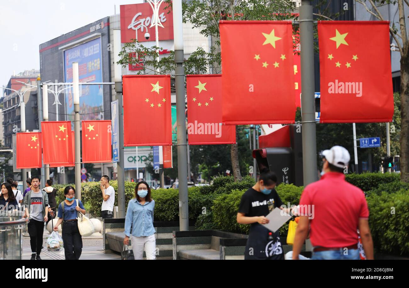 National flags of China are hung in the street light, welcoming the ...