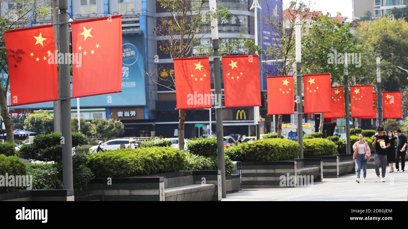National flags of China are hung in the street light, welcoming the ...