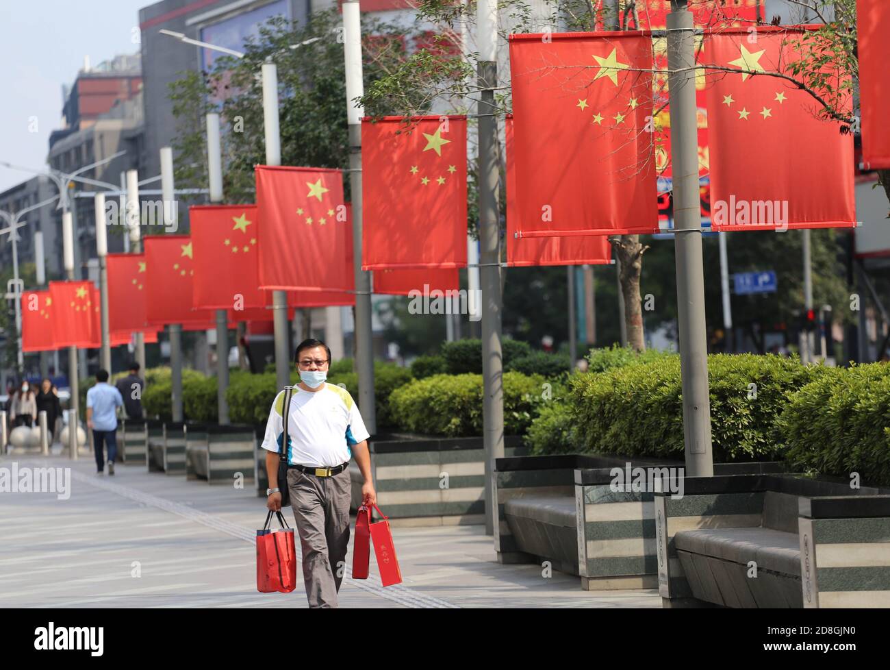 National flags of China are hung in the street light, welcoming the ...