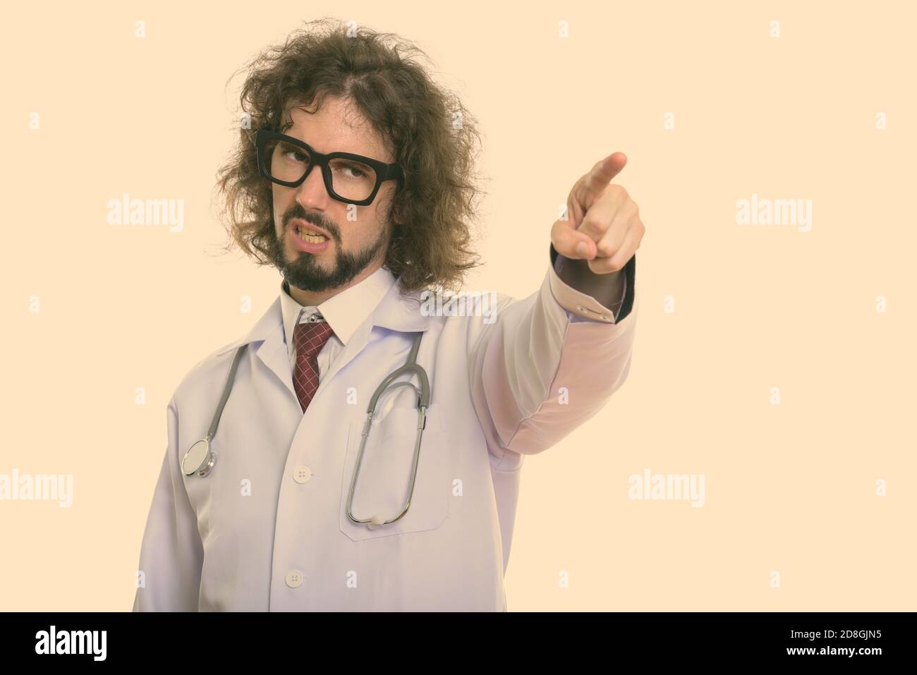Studio shot of angry man doctor pointing finger at distance Stock Photo ...