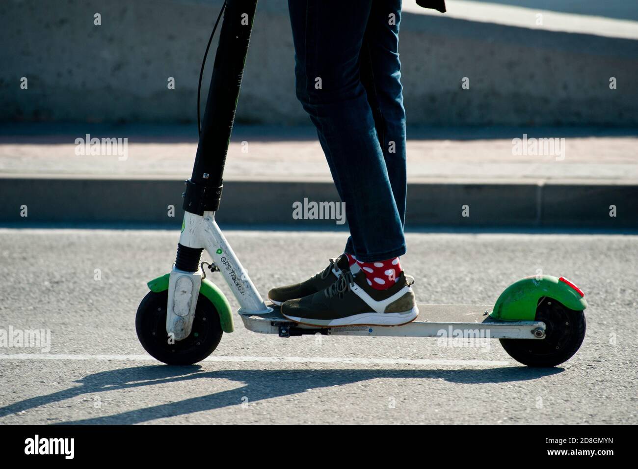 legs of boy riding electric scooter on the asphalt of the road Stock ...