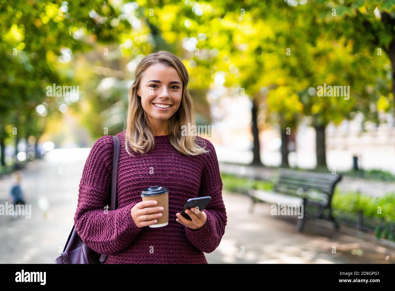Beautiful smiling mixed race girl reading message or browsing her ...