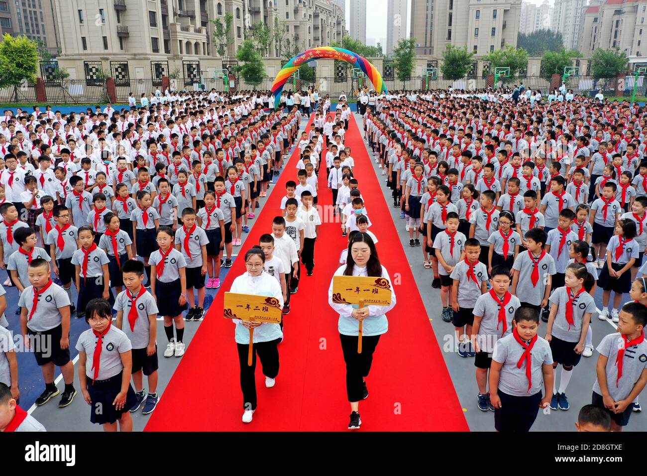 Students array on the playground, attending a ceremony to celebrate the ...