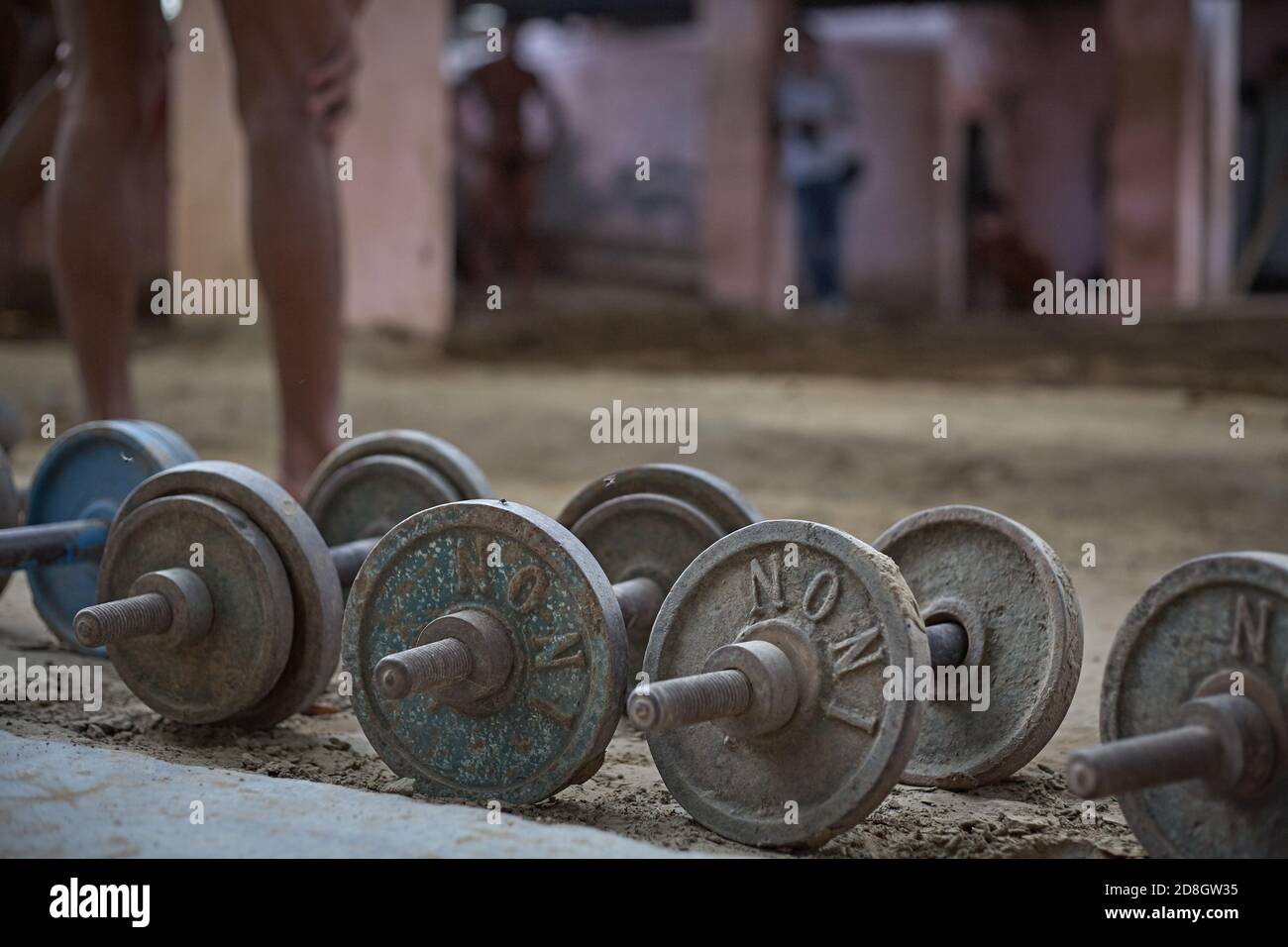Delhi, India, May 2012. Weights used by kushti wrestlers in their daily ...