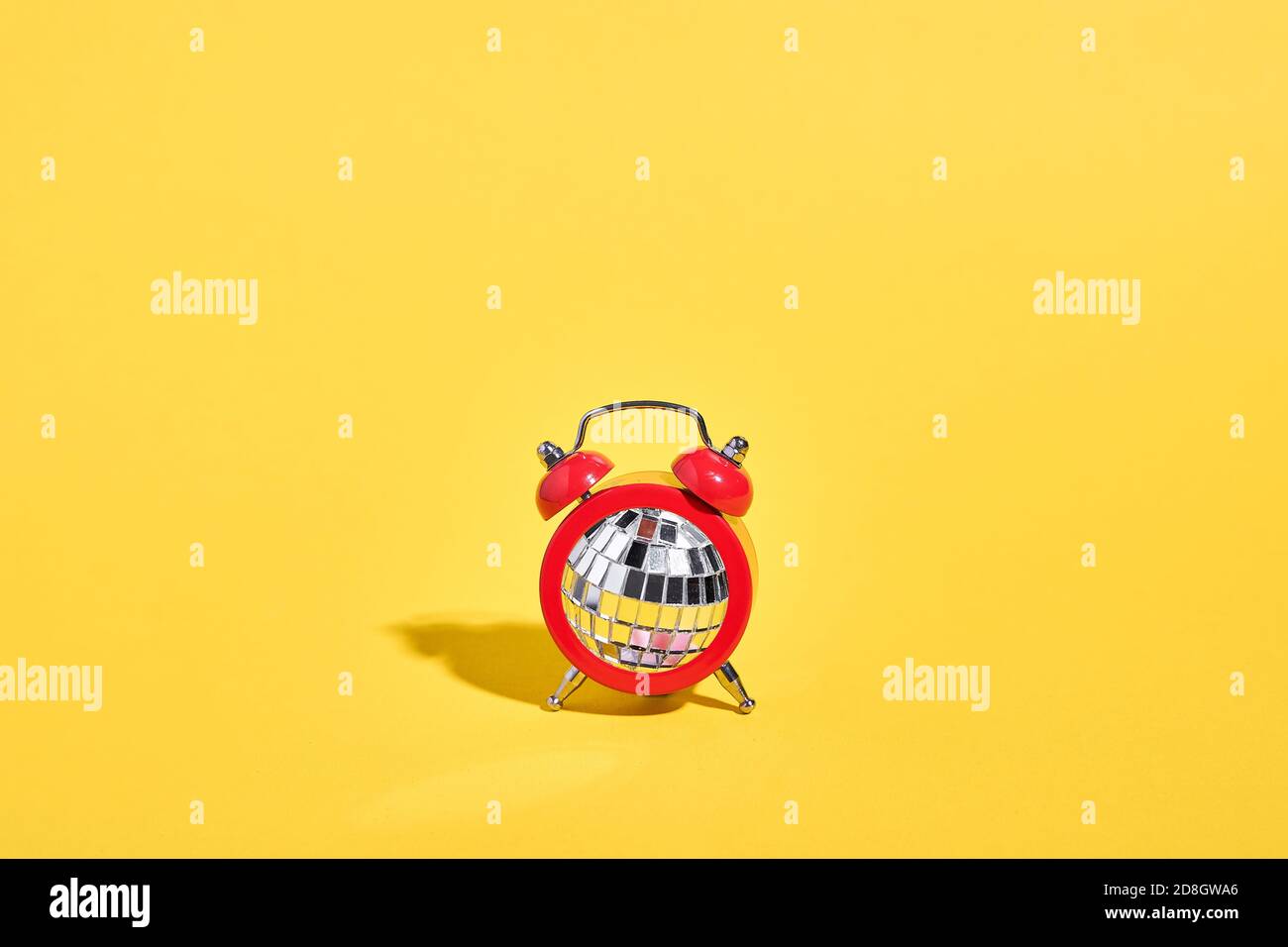 Red alarm clock with disco ball in it. christmas time Stock Photo - Alamy