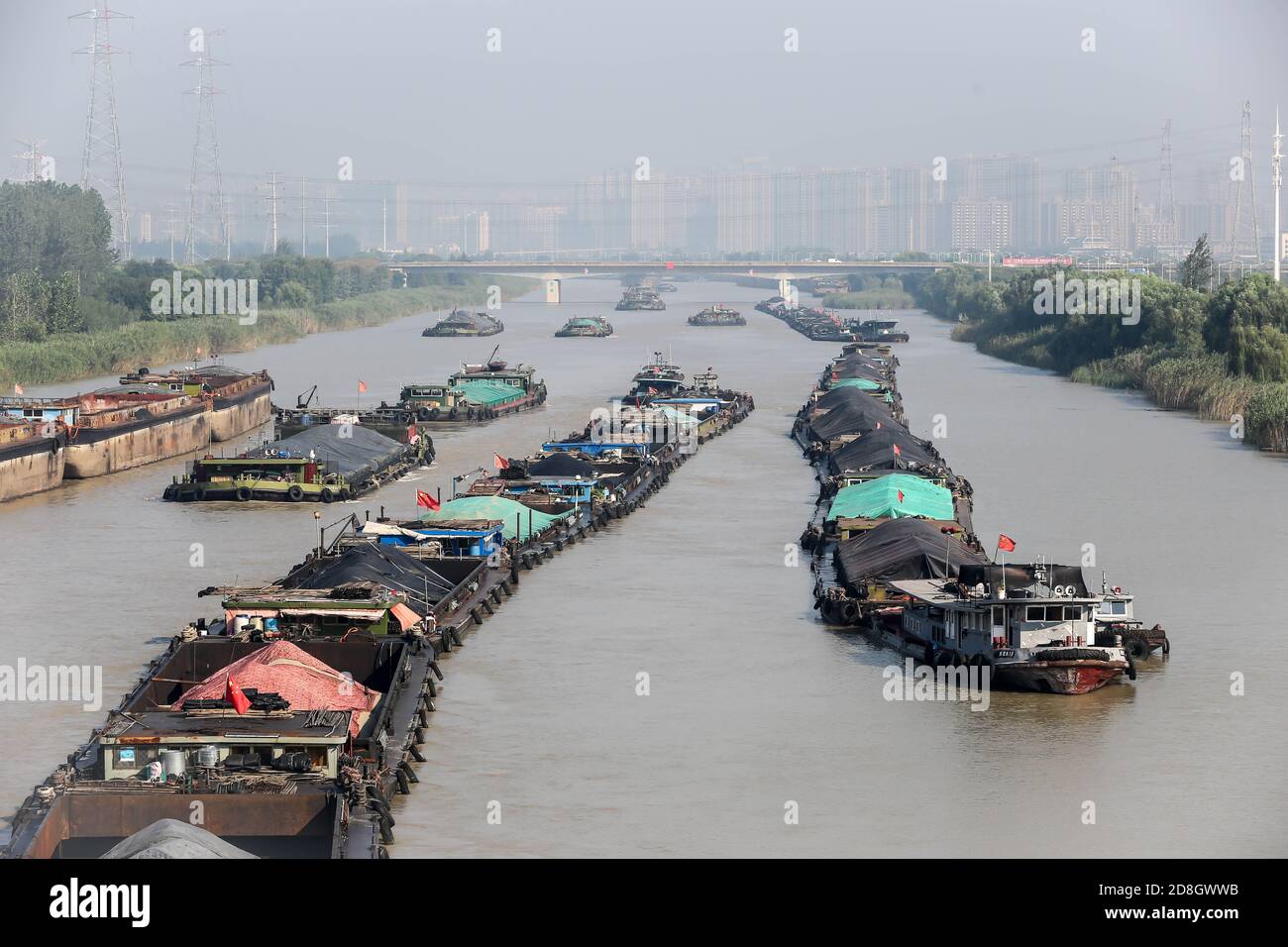 An aerial view of ships containing various kinds of goods moving on the ...