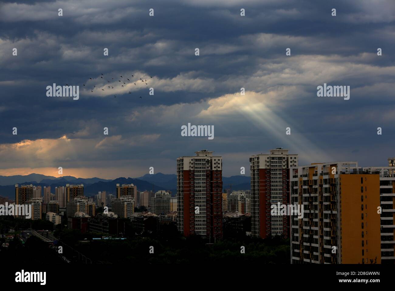 Dark clouds gather while silver lining seen on them, and sunshine goes ...