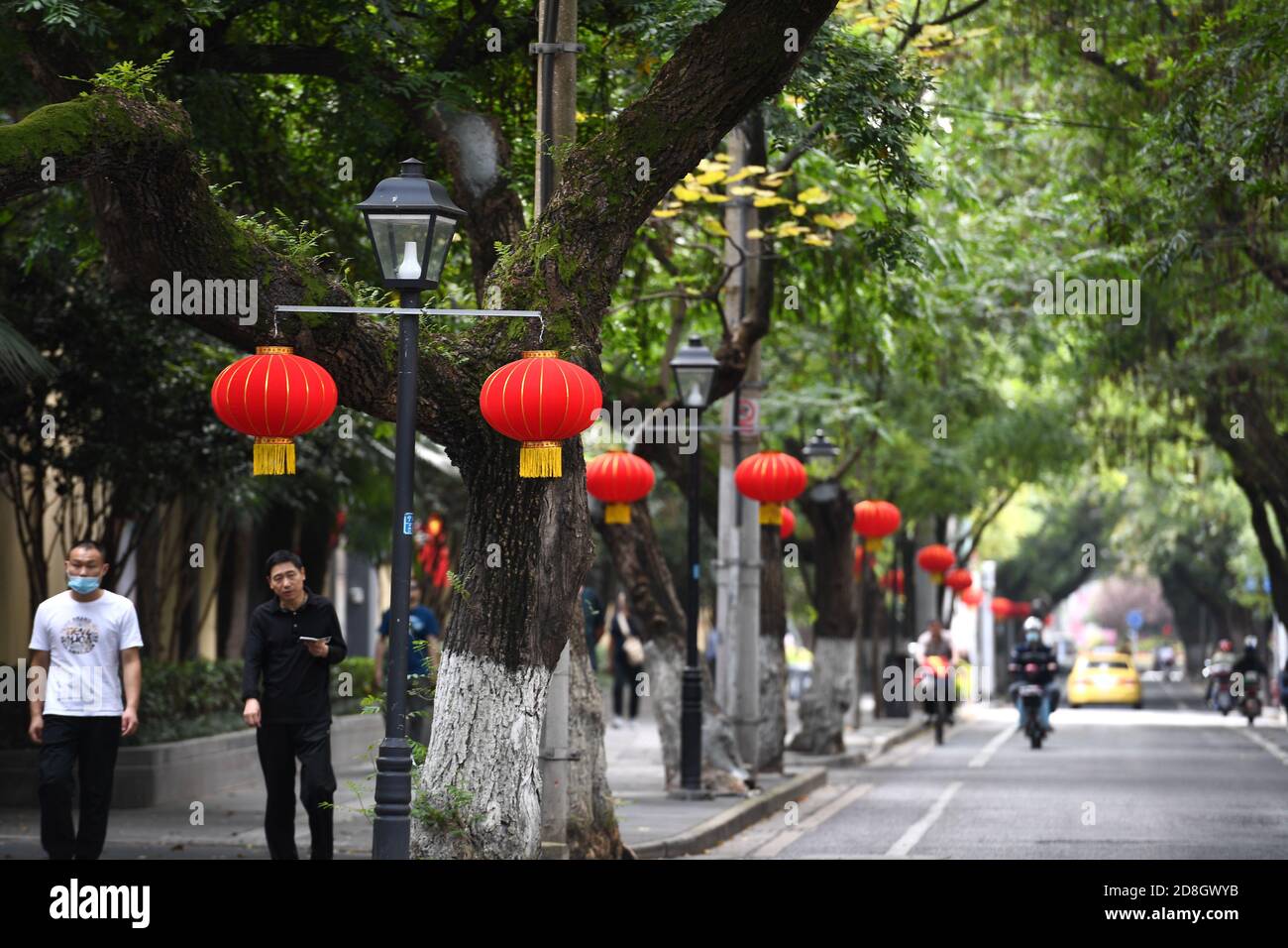 Red lanterns and national flags are seen flying along the Yihe street ...