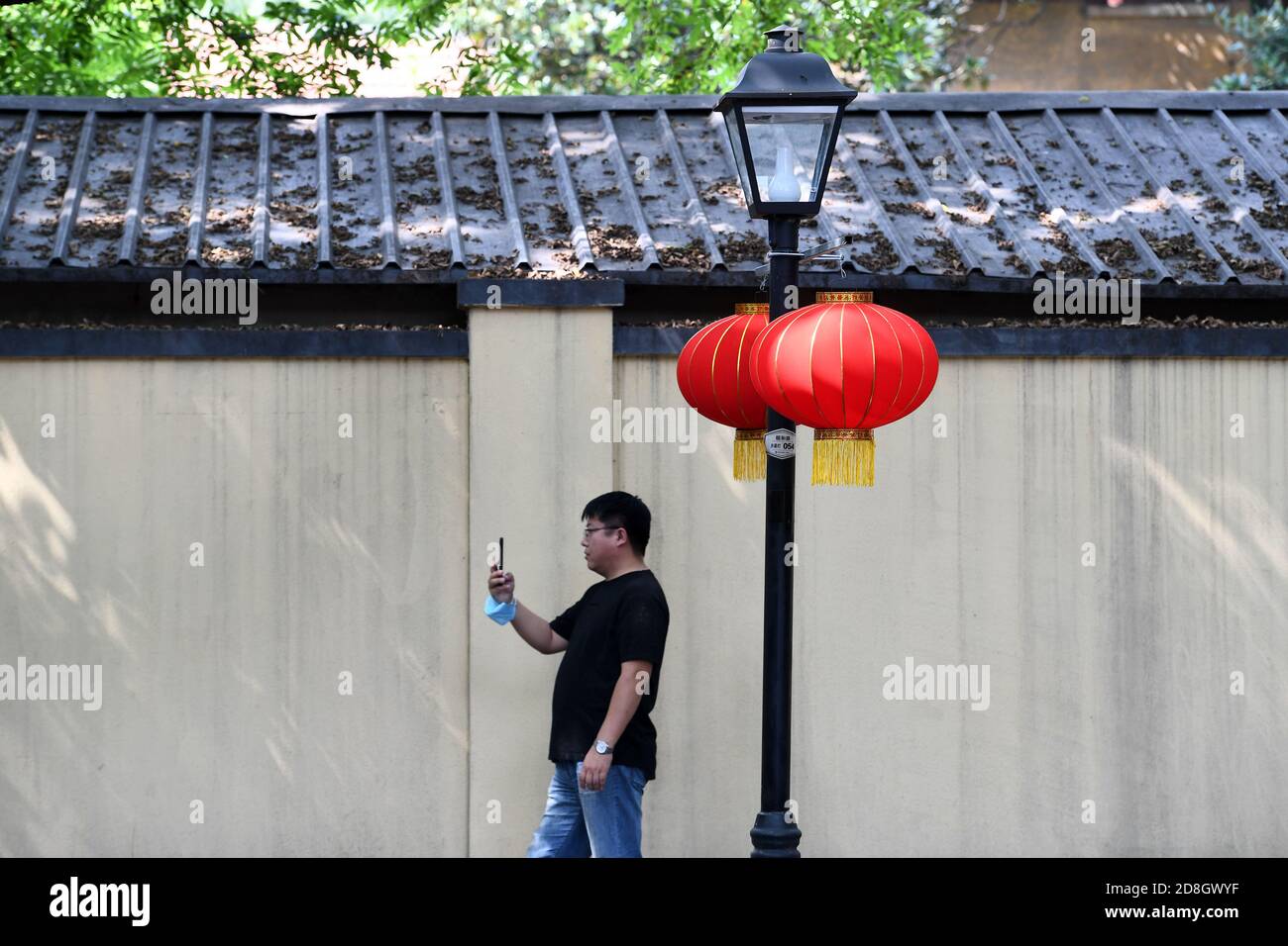 Red lanterns and national flags are seen flying along the Yihe street ...